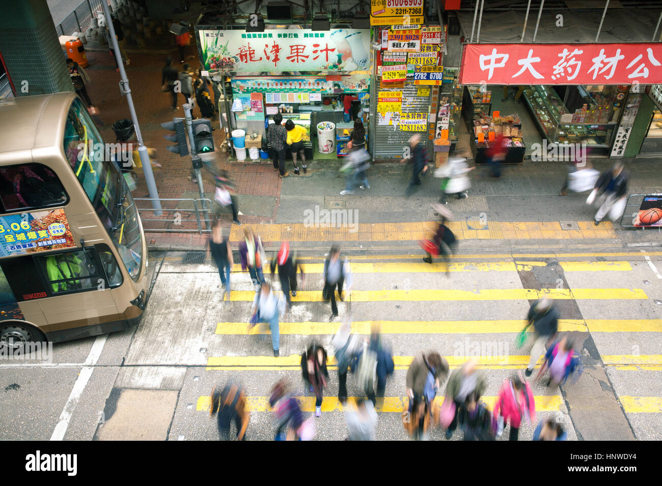 Hong Kong - FEBRUARY 18: People crossing the street at Mong Kok ...