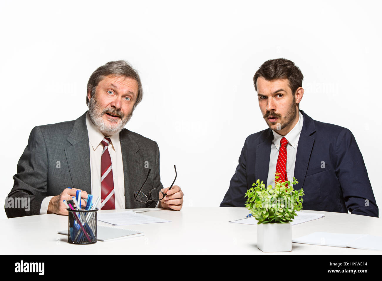 The two colleagues working together at office on white studio ...