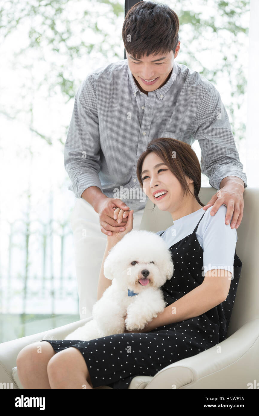 Loving couple with pet Stock Photo - Alamy