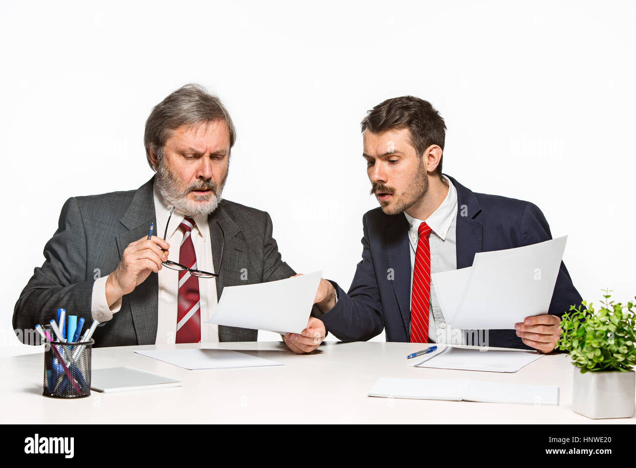 The two colleagues working together at office on white studio ...