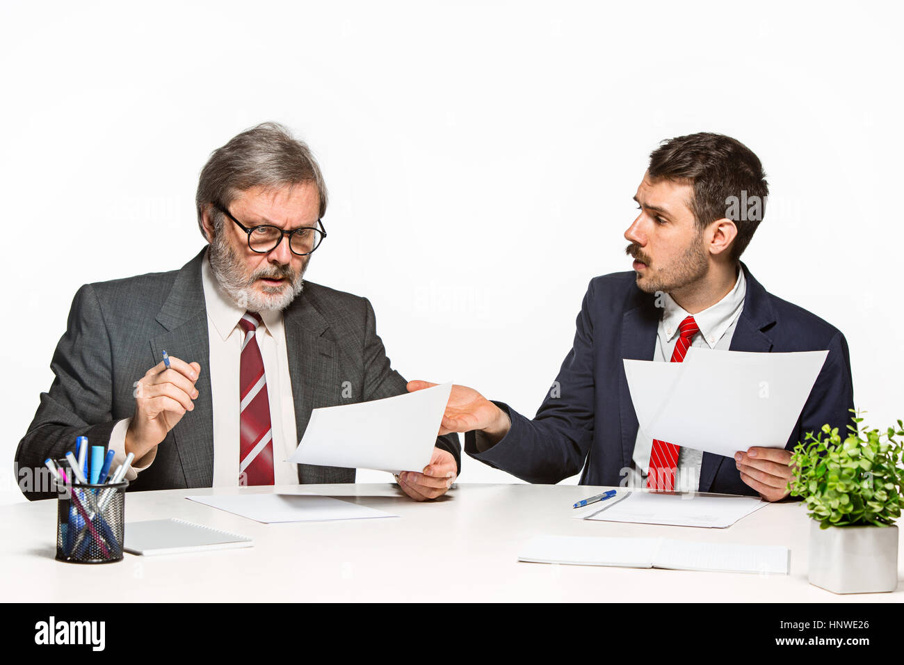 The two colleagues working together at office on white studio ...