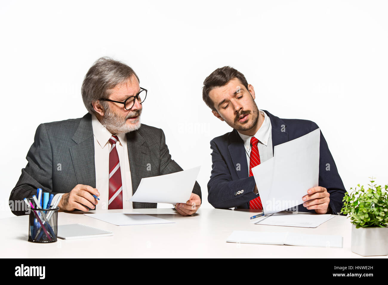 The two colleagues working together at office on white studio ...