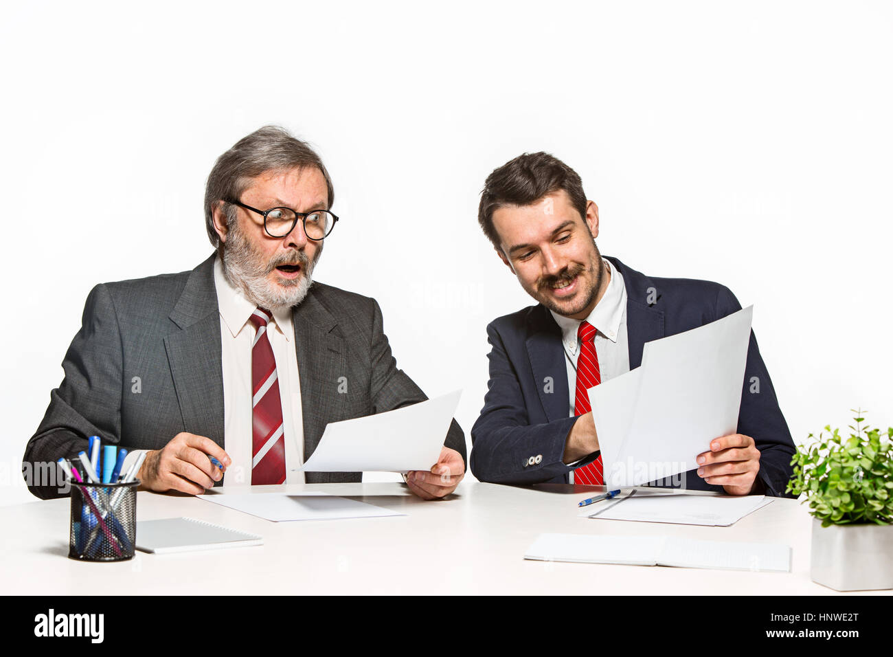 The two colleagues working together at office on white studio ...