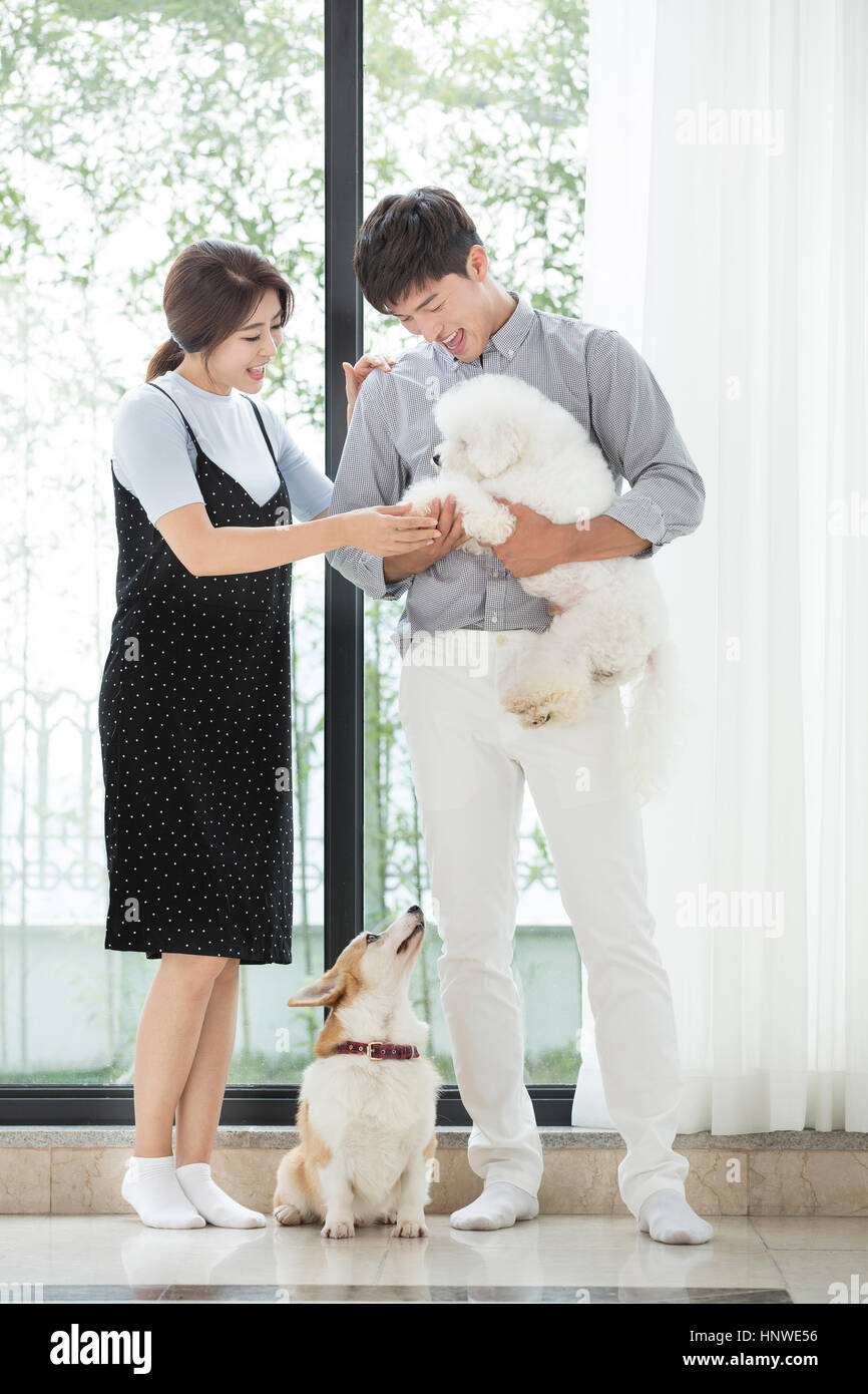 Smiling couple with pets Stock Photo - Alamy