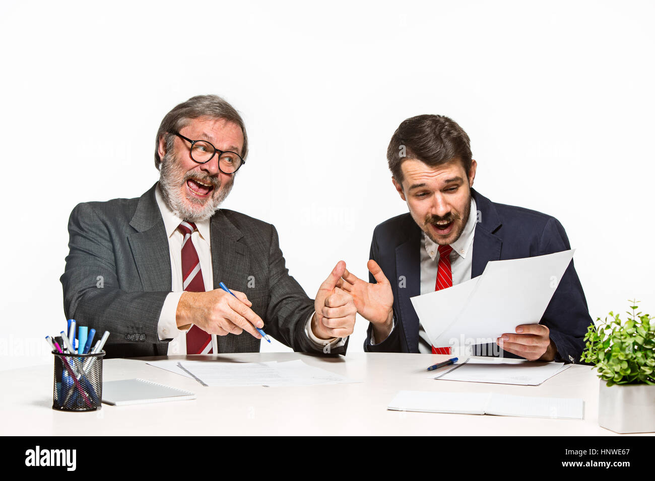 The two colleagues working together at office on white studio ...