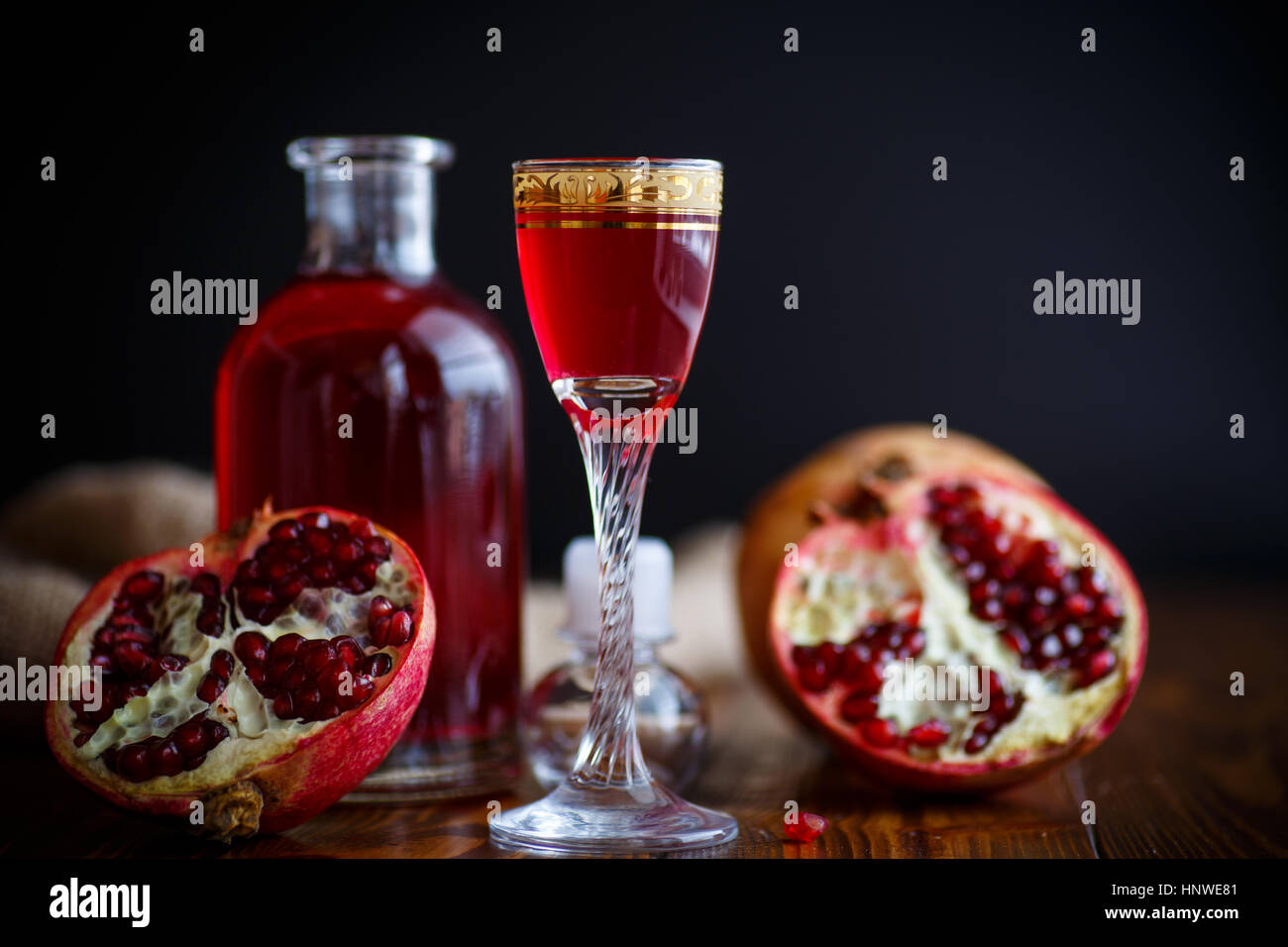 sweet pomegranate fruit alcoholic cordial in the decanter with a glass ...