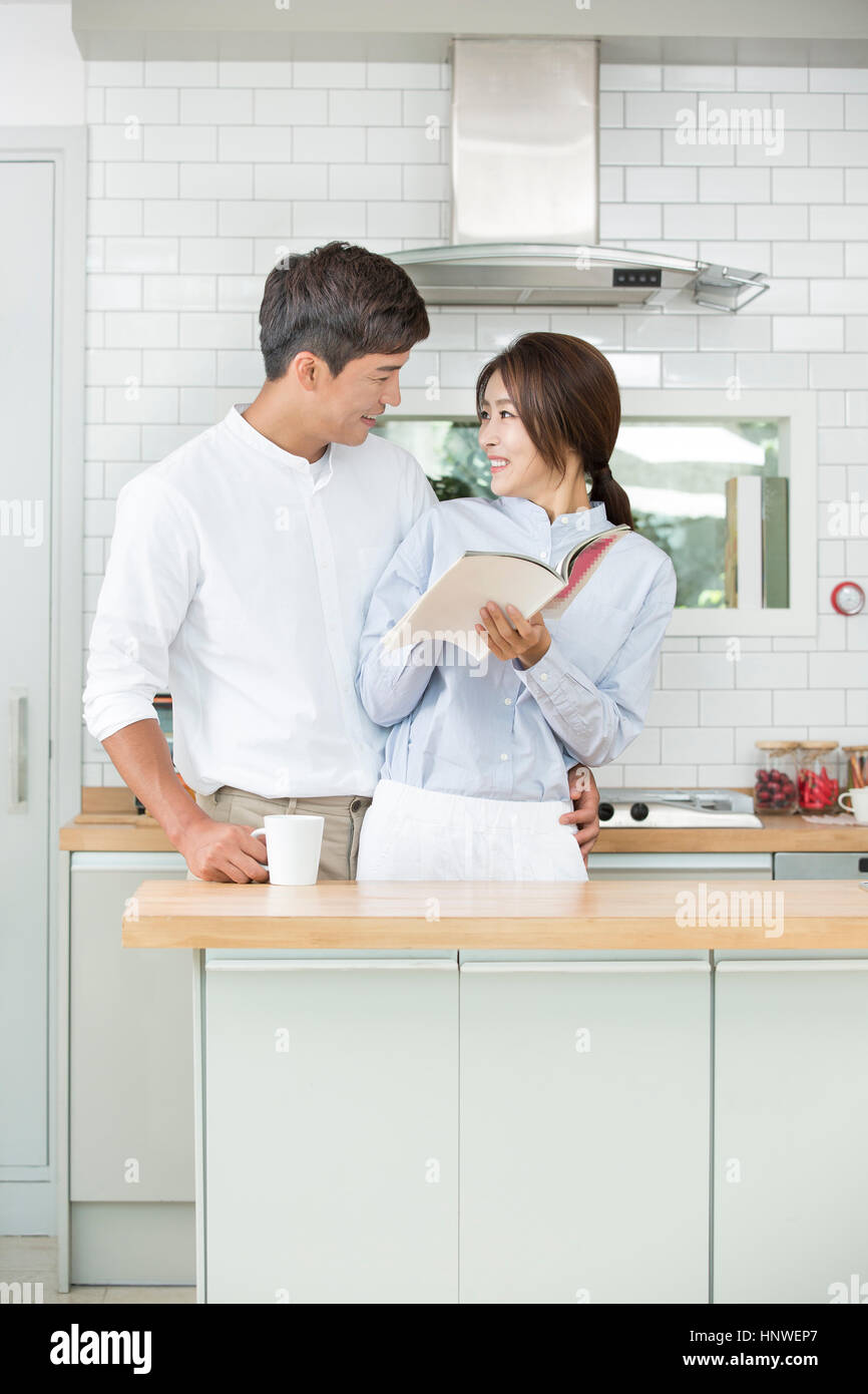 Loving couple in kitchen Stock Photo - Alamy