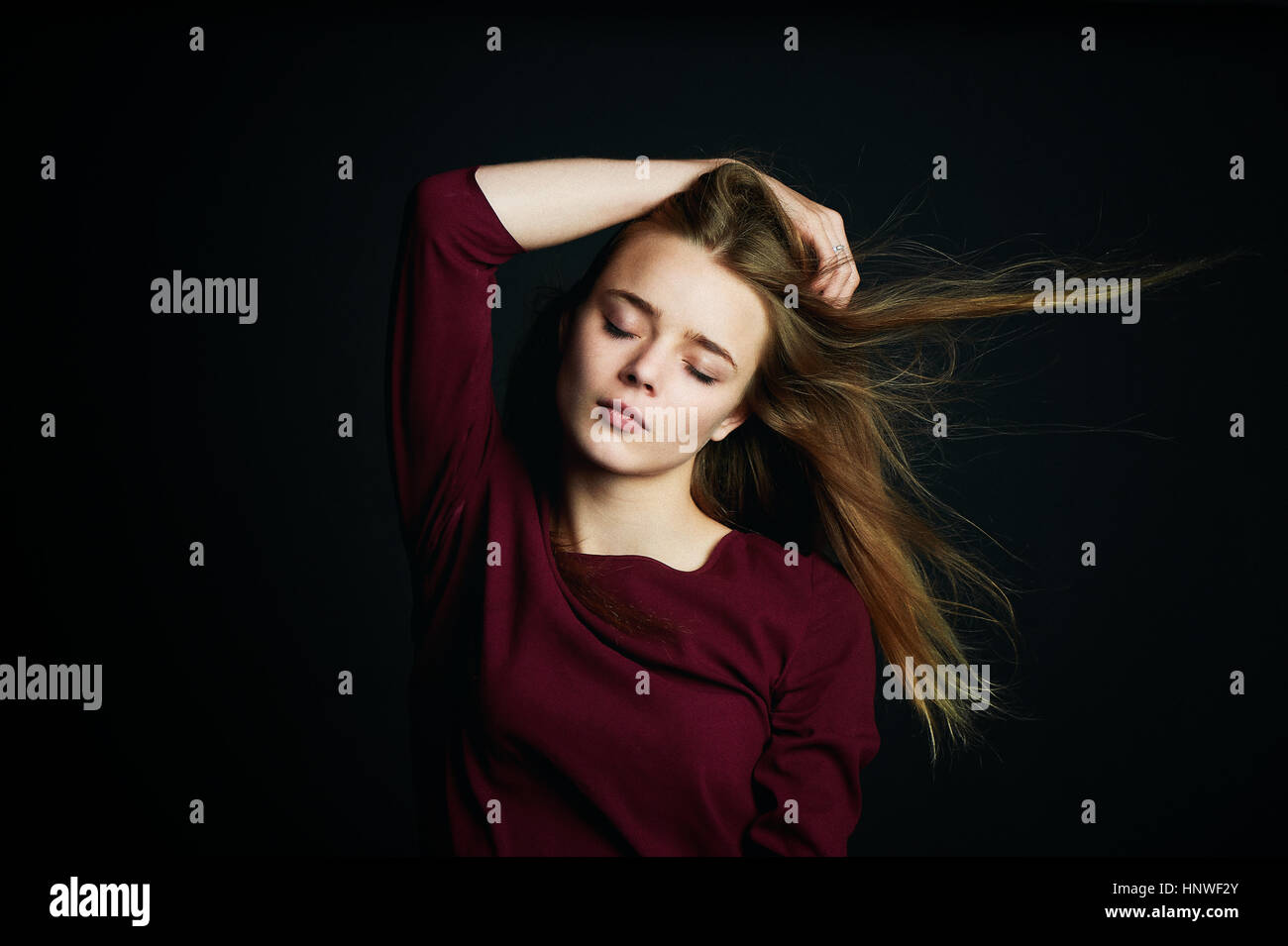 The hand in her hair. Beautiful young girl dancing. Hair flying ...