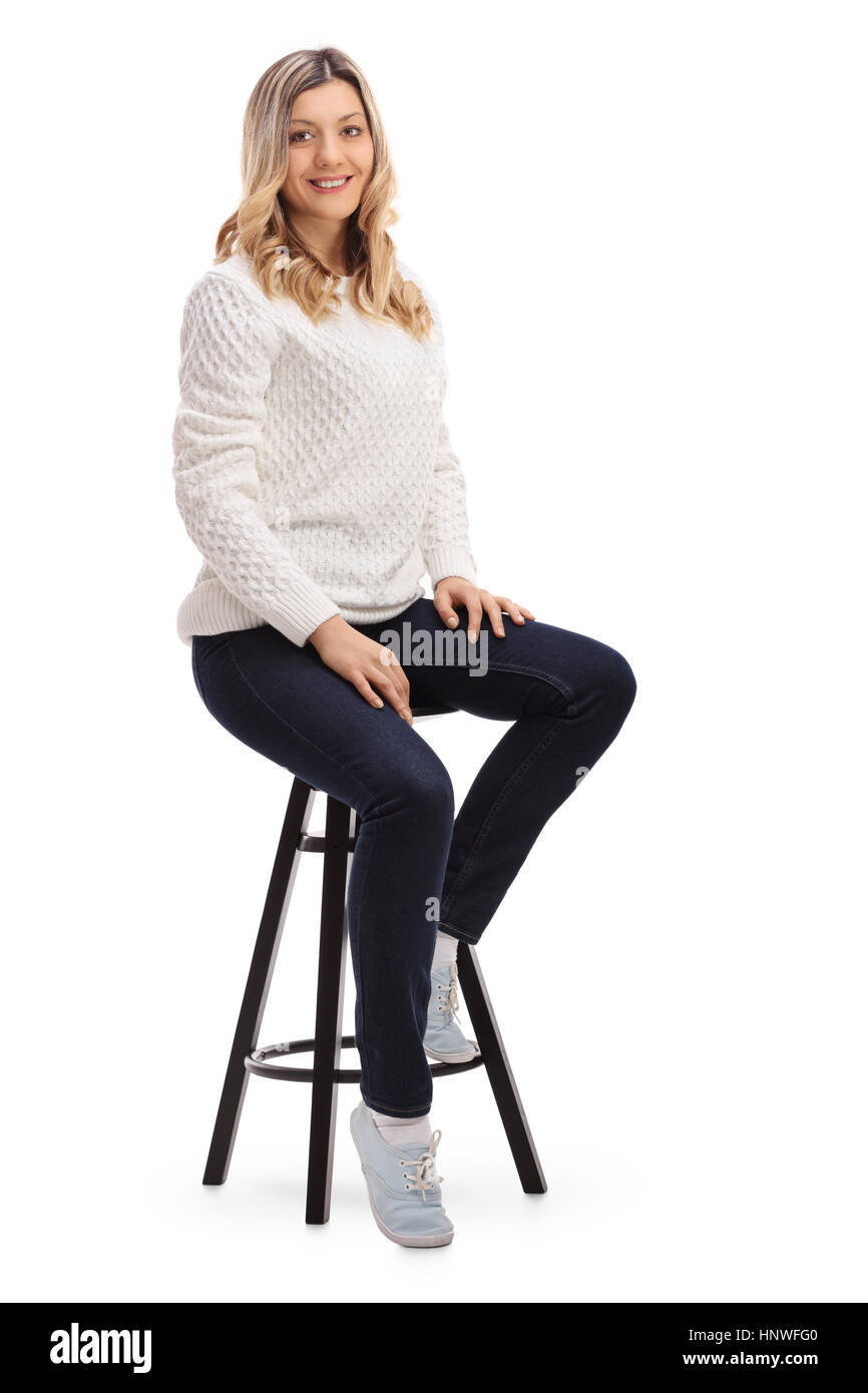 Pretty woman sitting on a chair smiling and looking at the camera ...