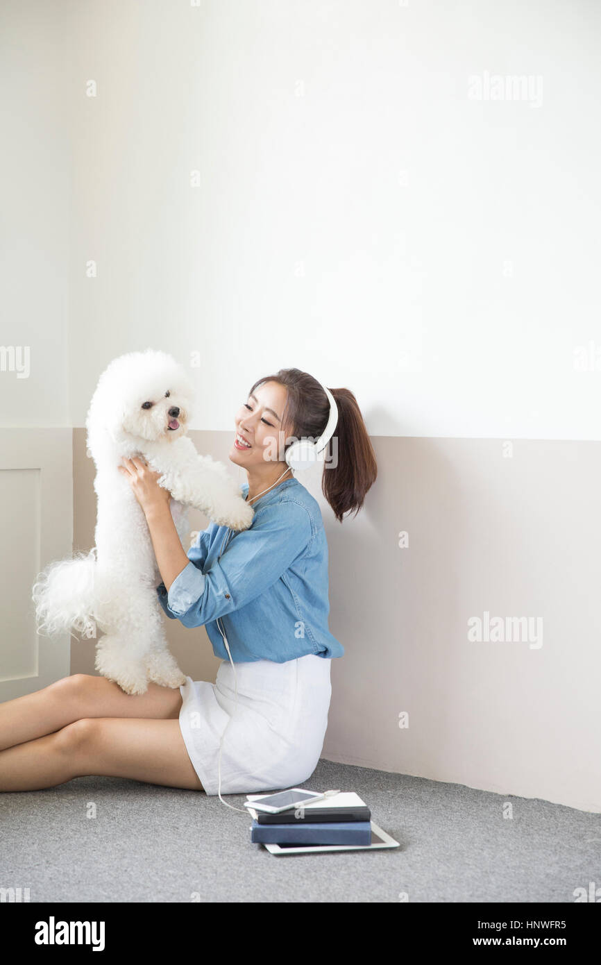 Smiling woman lifting dog hi-res stock photography and images - Alamy