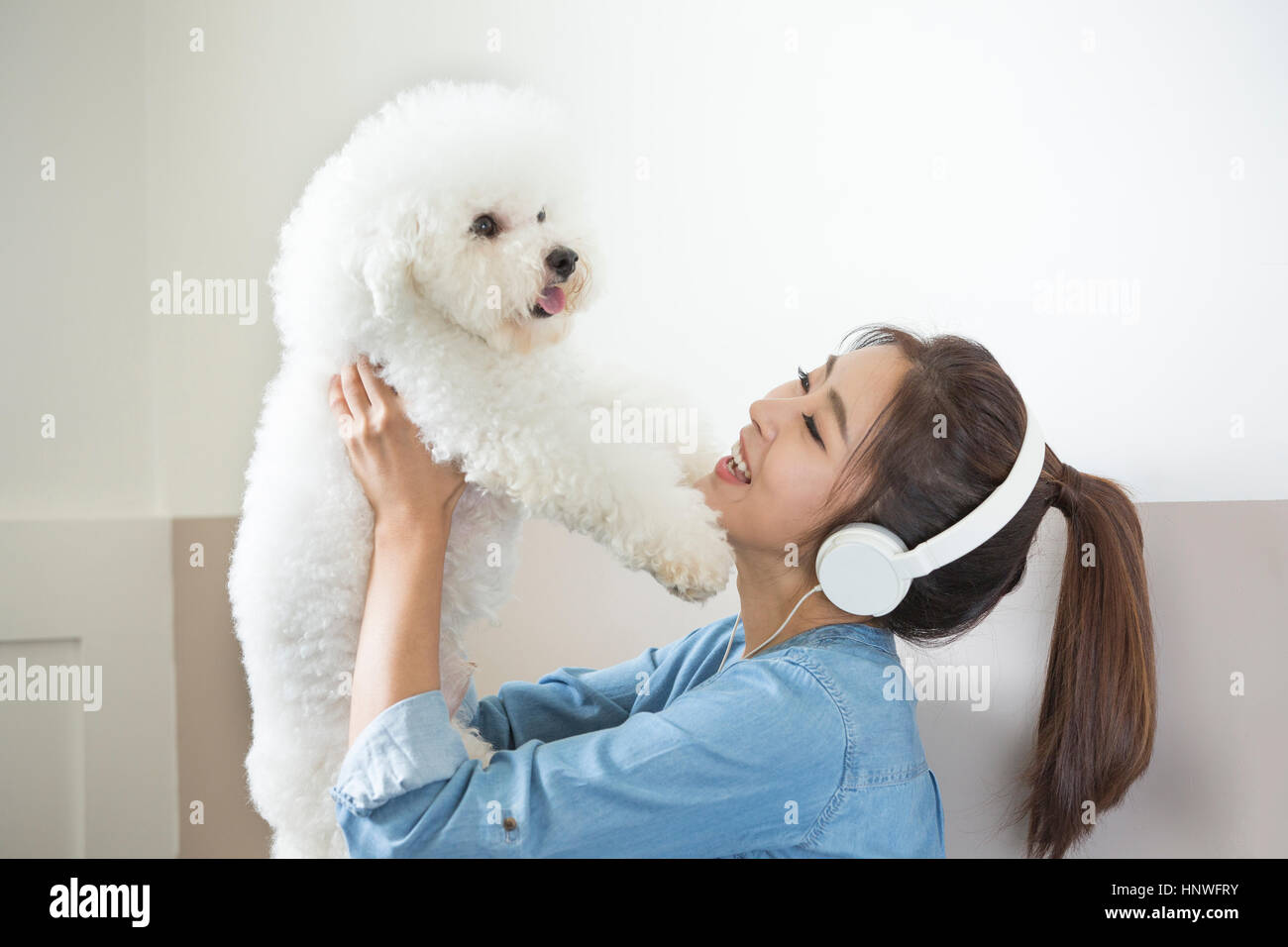 Smiling woman lifting dog hi-res stock photography and images - Alamy