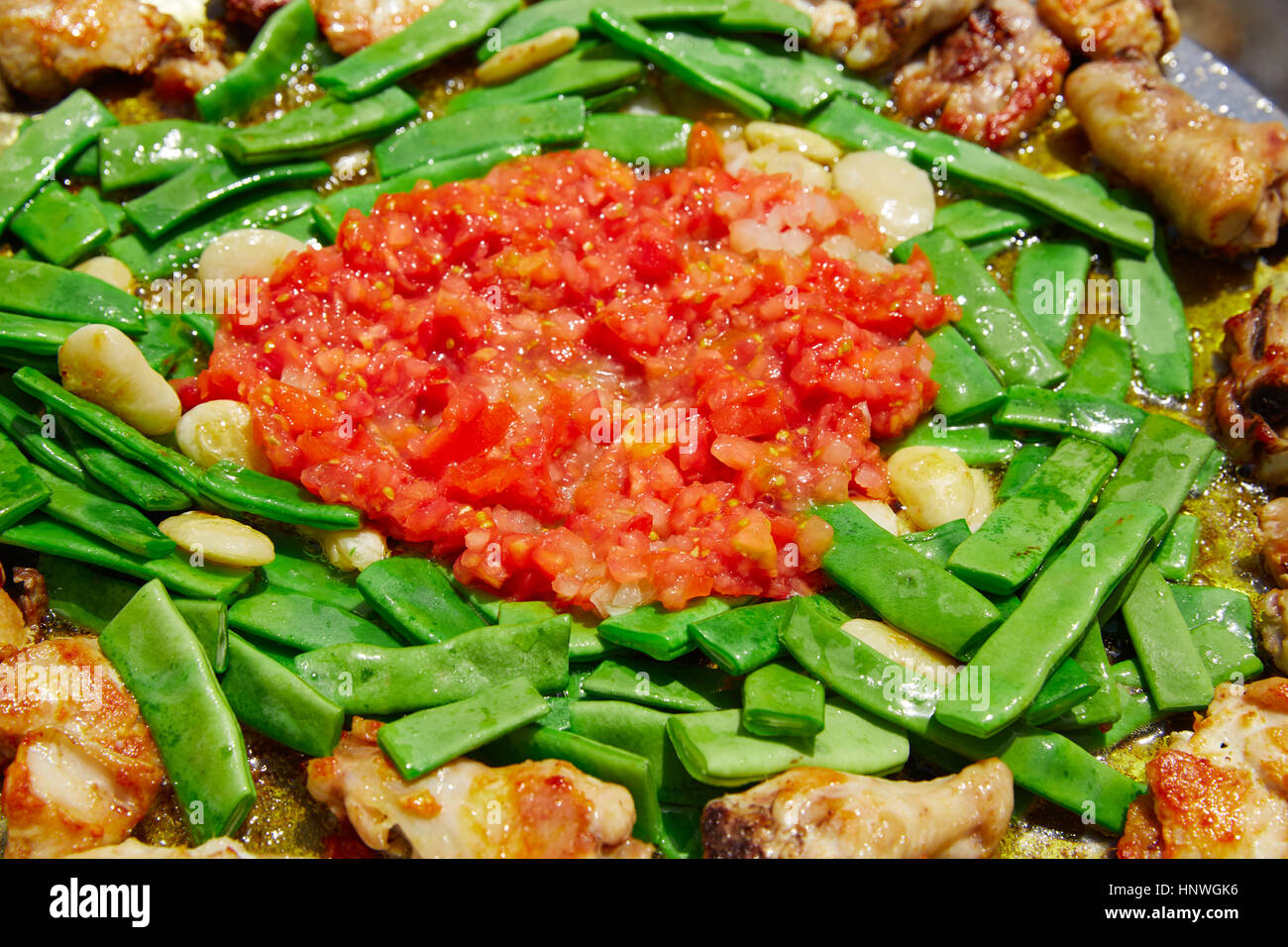 Paella from Spain recipe process ad vegetables green beans and tomato ...