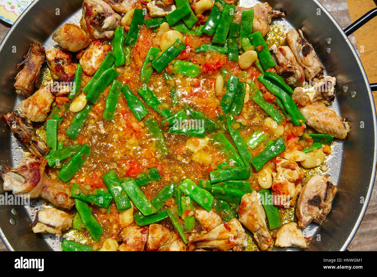 Paella from Spain recipe process ad vegetables green beans and tomato ...