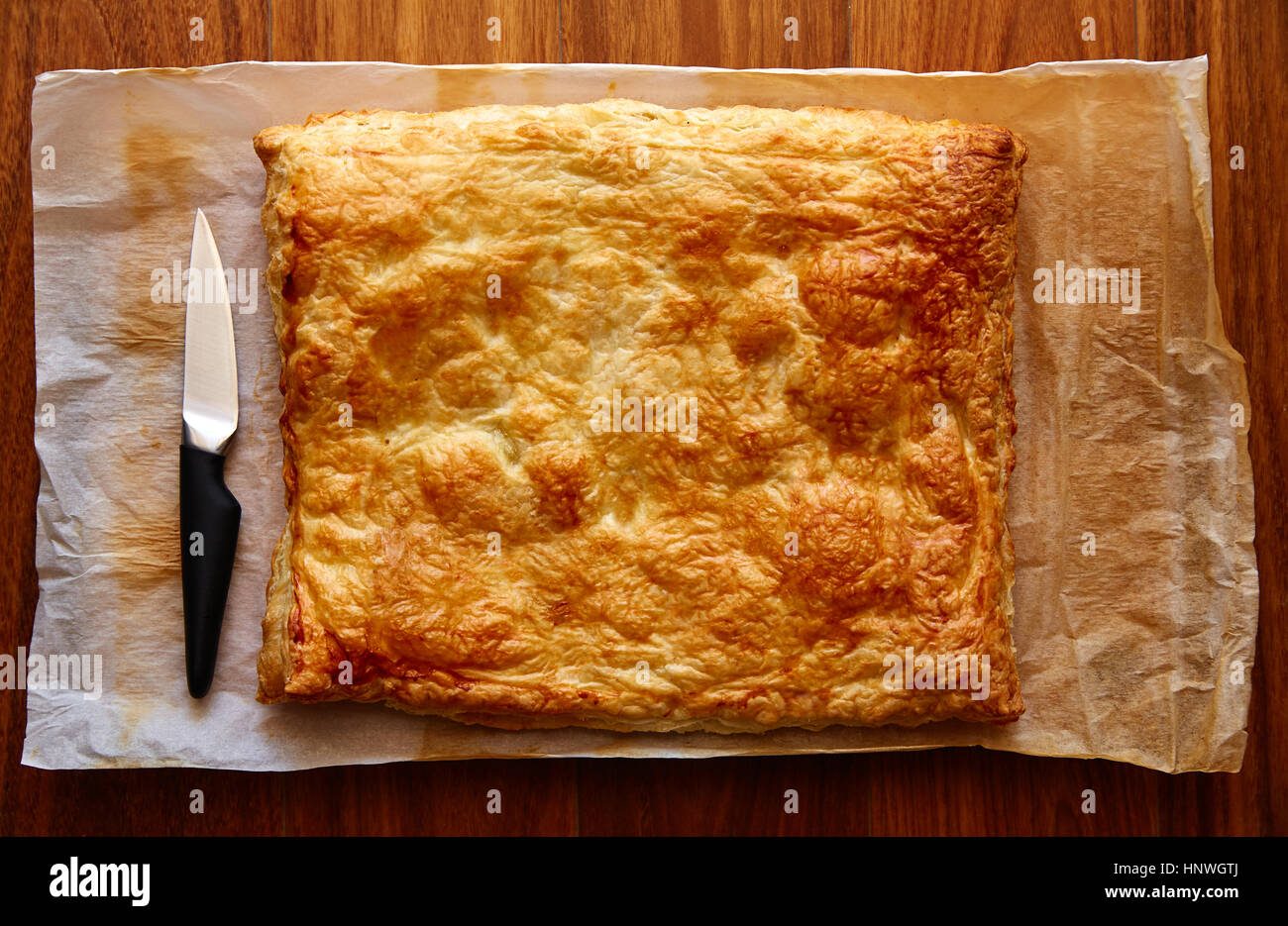 Puff vegratables pastry square shape with knife on oven paper Stock ...
