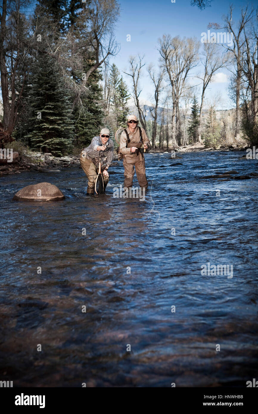 Fishermen ankle deep in river fly fishing, Colorado, USA Stock Photo ...