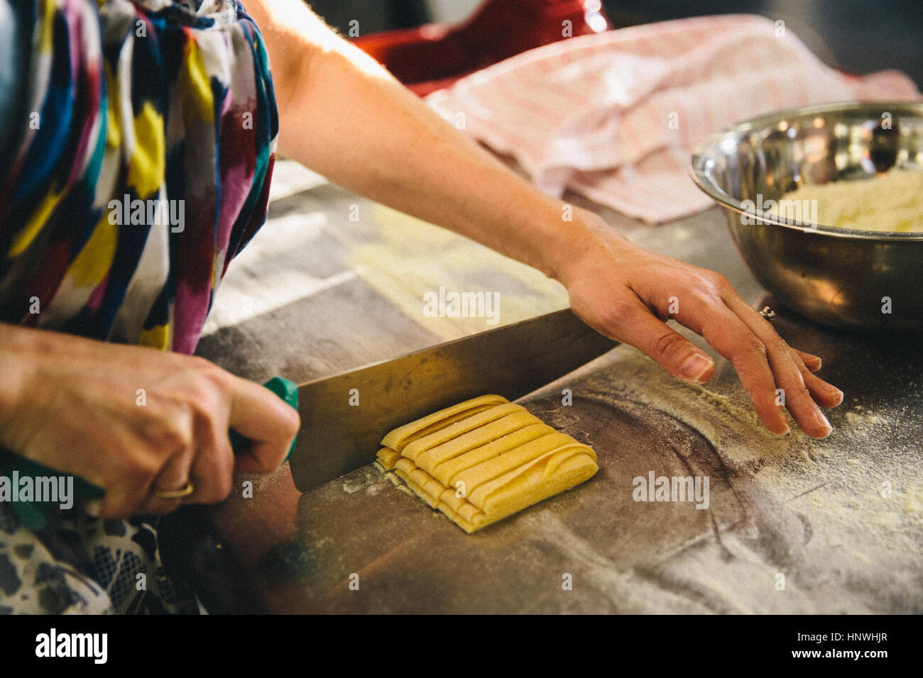 Woman cutting pasta dough with knife Stock Photo - Alamy