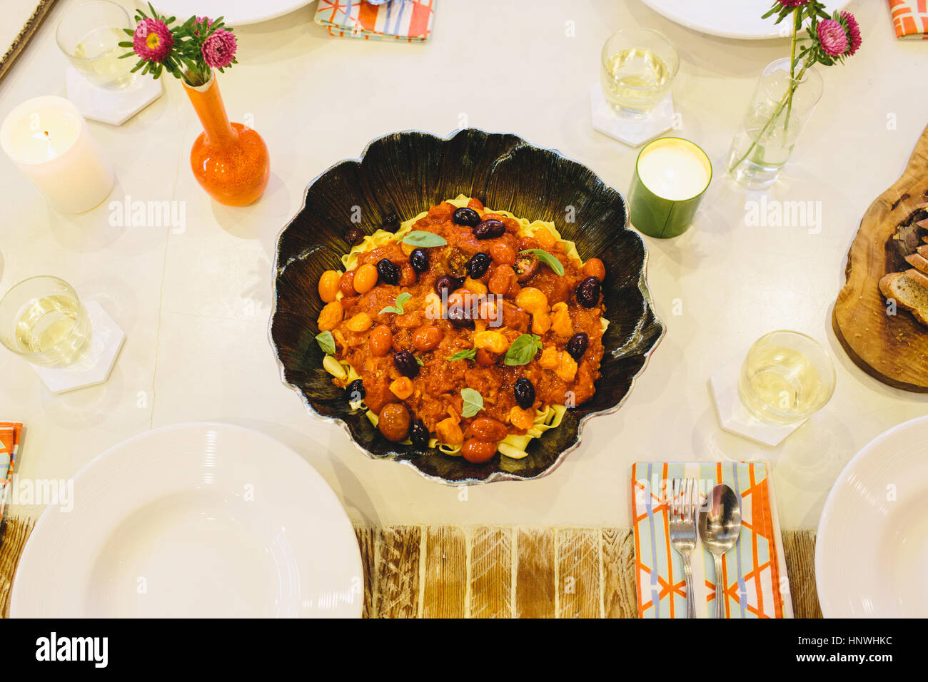 Serving of pasta on dining table Stock Photo - Alamy