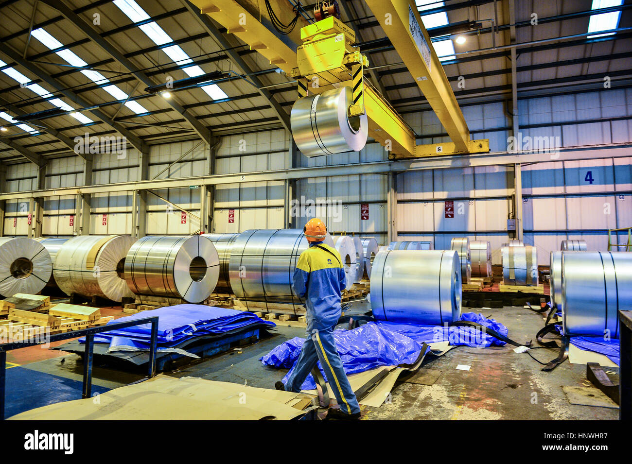 Steel worker uses a crane to handle rolls of steel at Tata Steel's ...