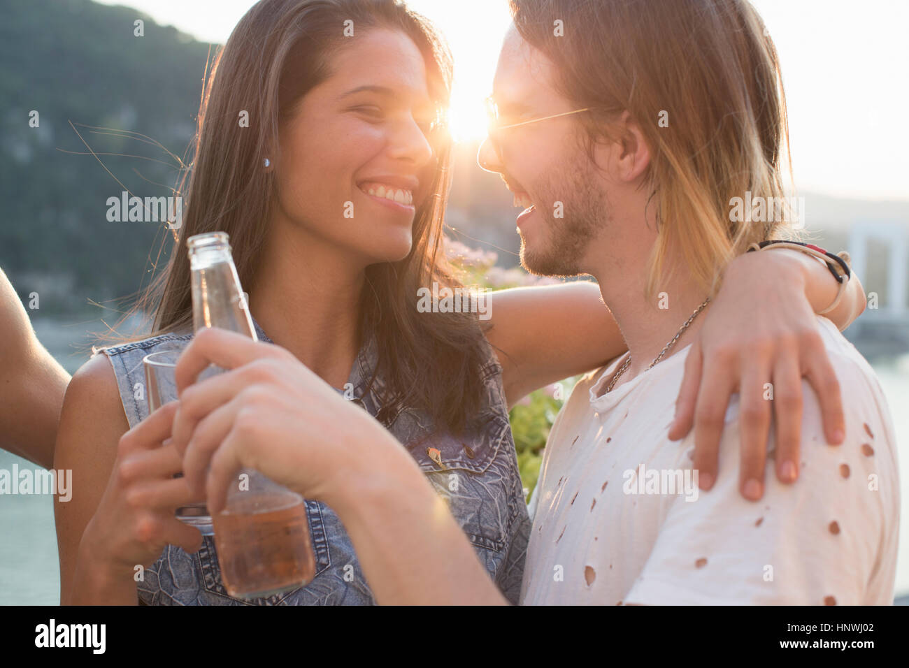 Happy young couple at sunset roof terrace party, Budapest, Hungary ...