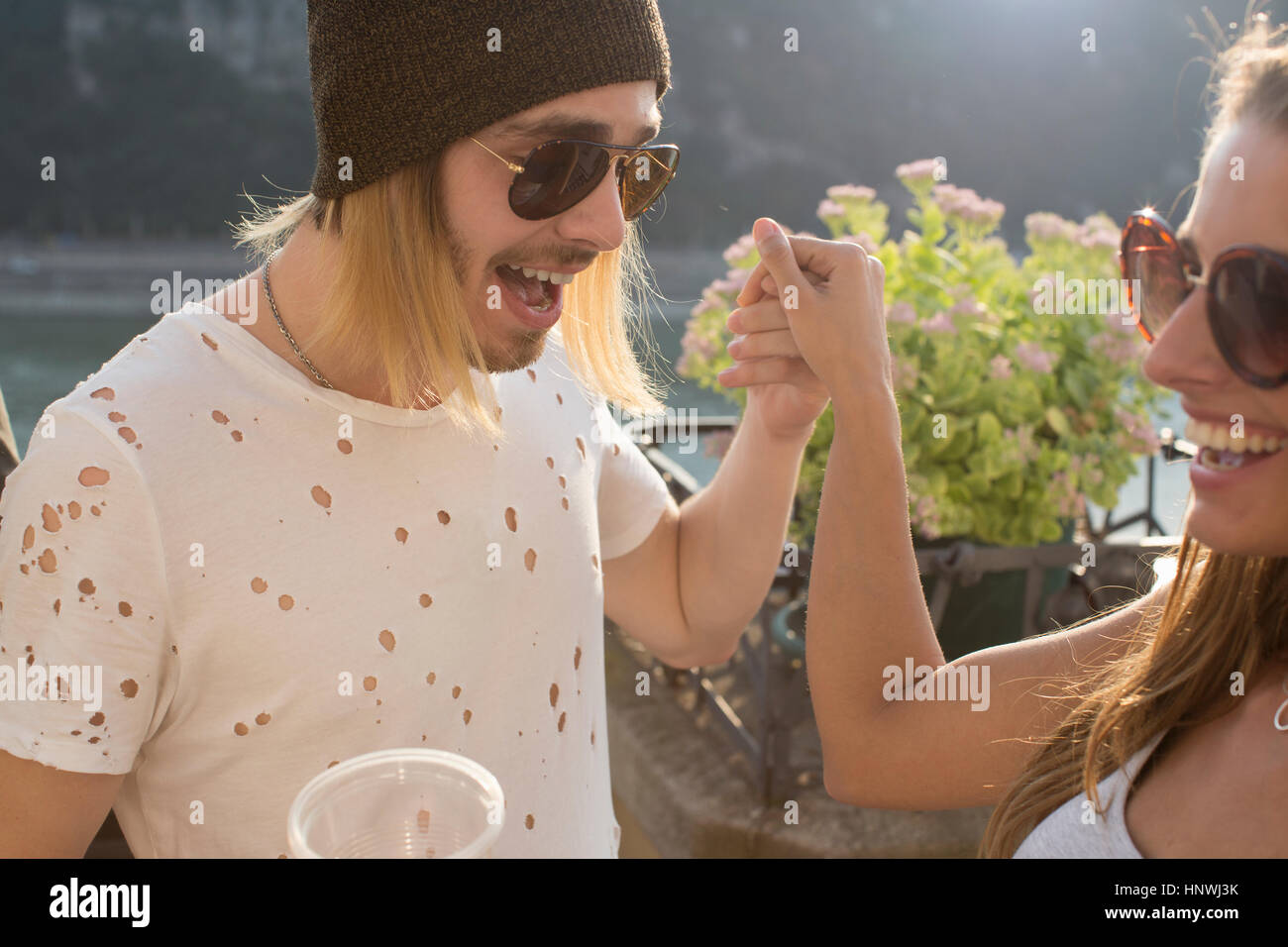 Happy couple dancing at waterfront roof terrace party, Budapest ...
