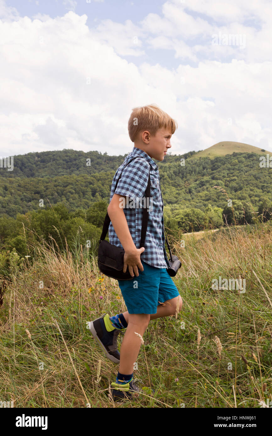 Young boy exploring outdoors Stock Photo - Alamy
