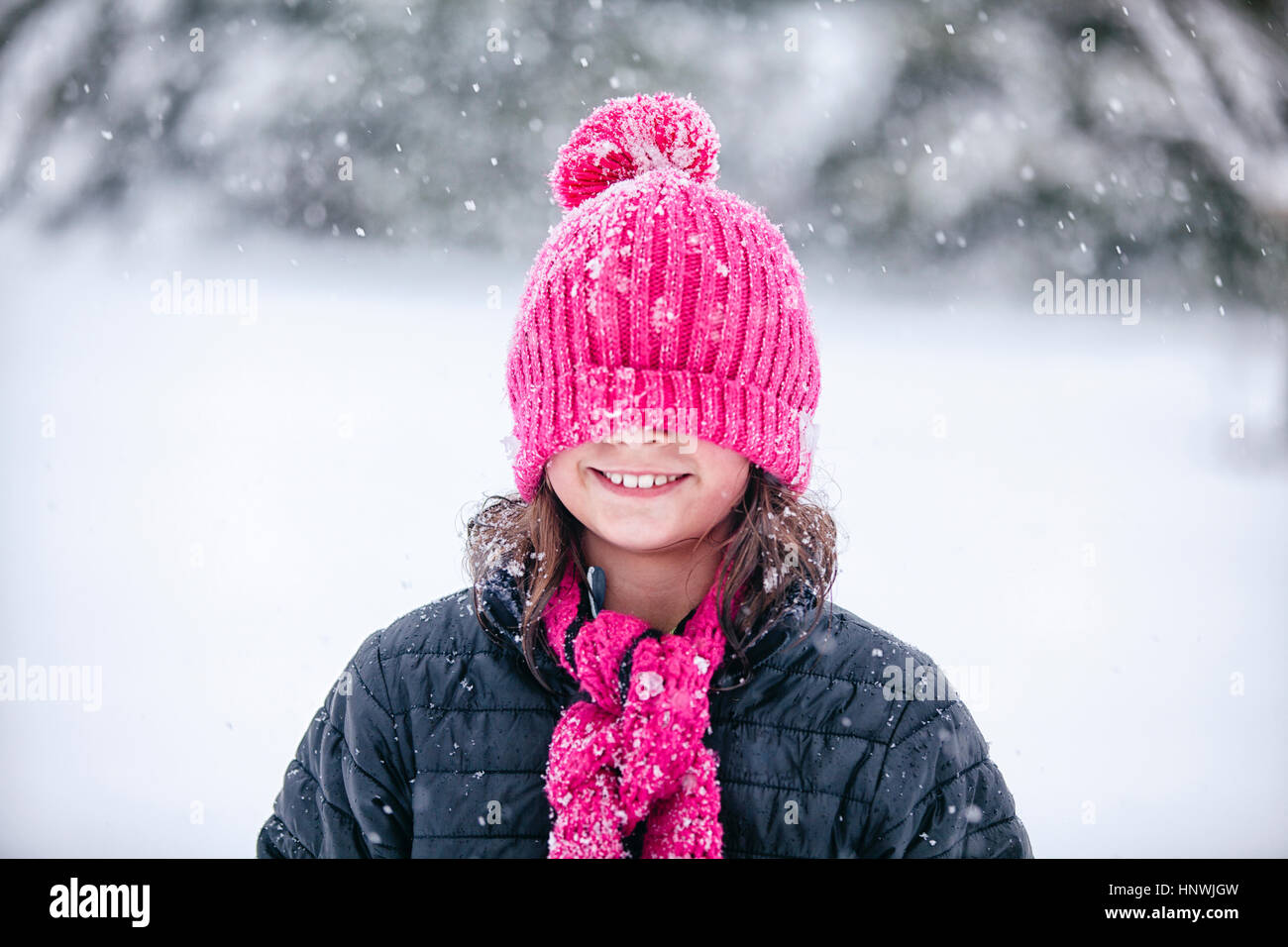Girl with pink knitted hat pulled over eyes Stock Photo - Alamy
