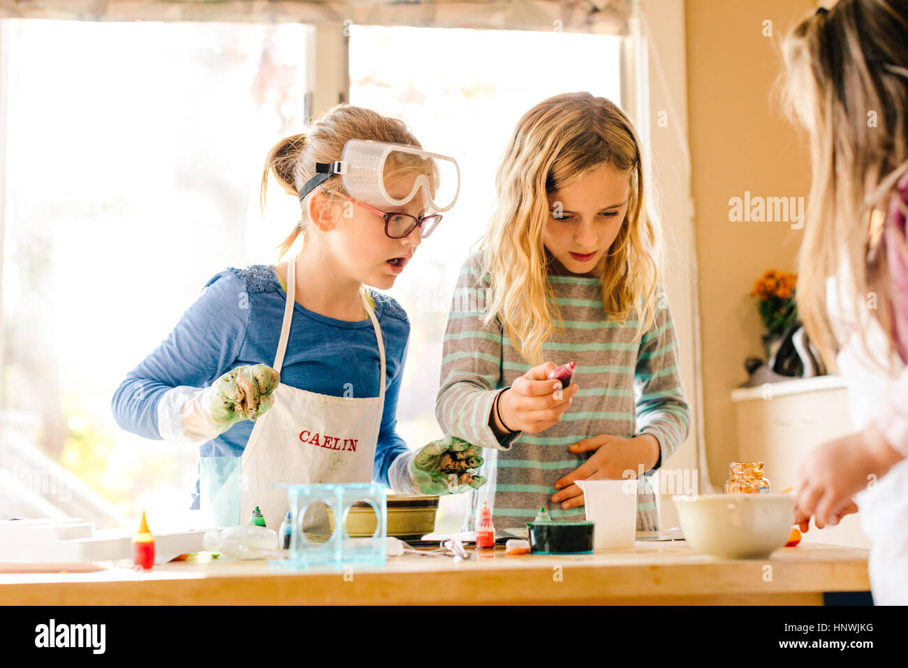 Three surprised girls doing science experiment, staring Stock Photo - Alamy