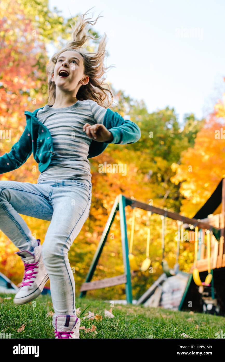 Girl playing and jumping in garden Stock Photo - Alamy