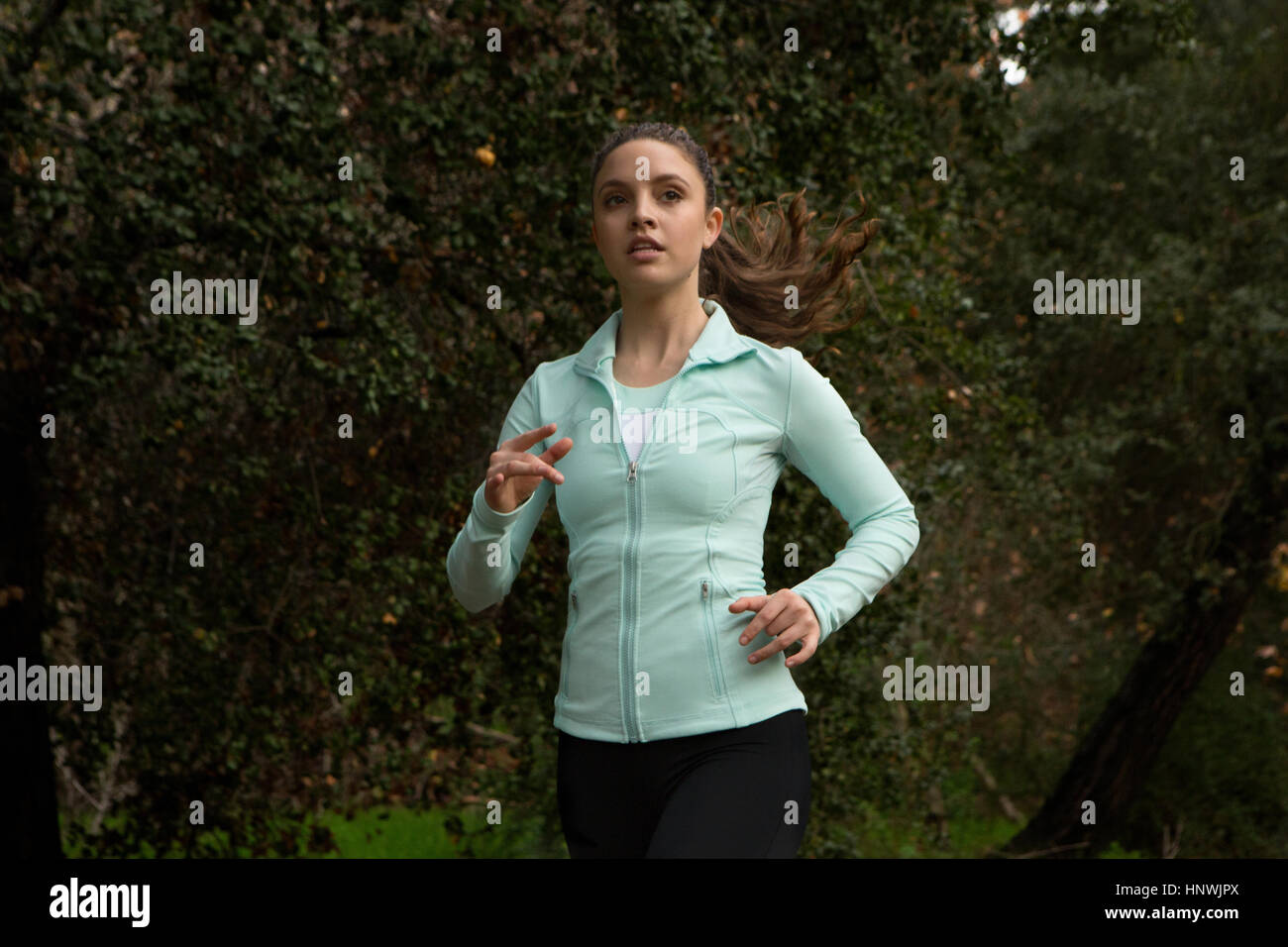 Young woman exercising, running, outdoors Stock Photo - Alamy