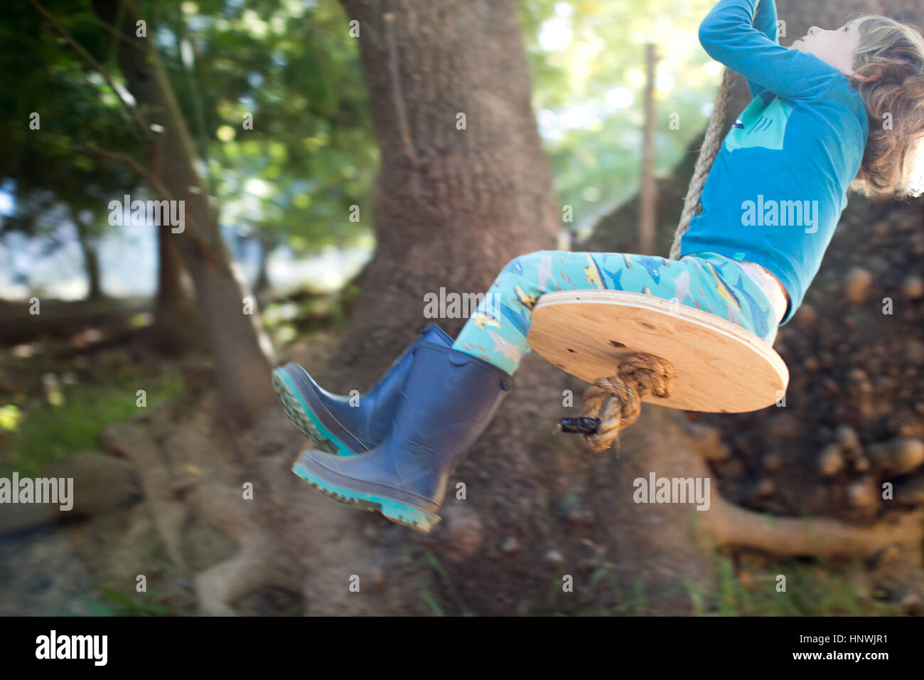 Child swinging on rope hi-res stock photography and images - Alamy