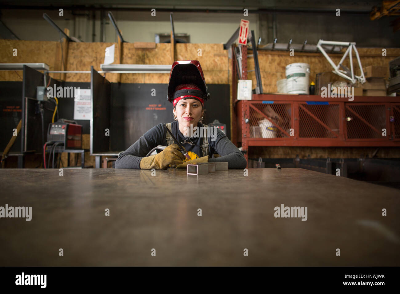 Portrait of female metalsmith at workshop bench Stock Photo - Alamy