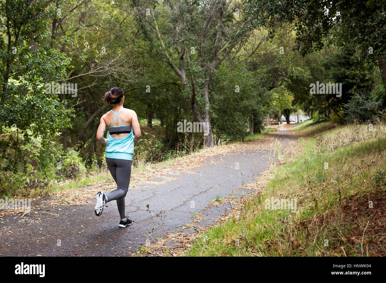 Rear view of female runner running in park Stock Photo - Alamy