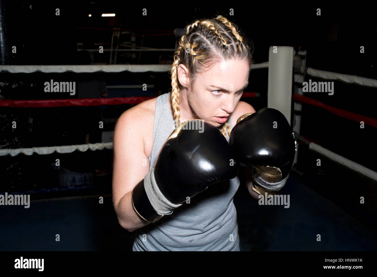 Female boxer poised for sparring in boxing ring Stock Photo - Alamy