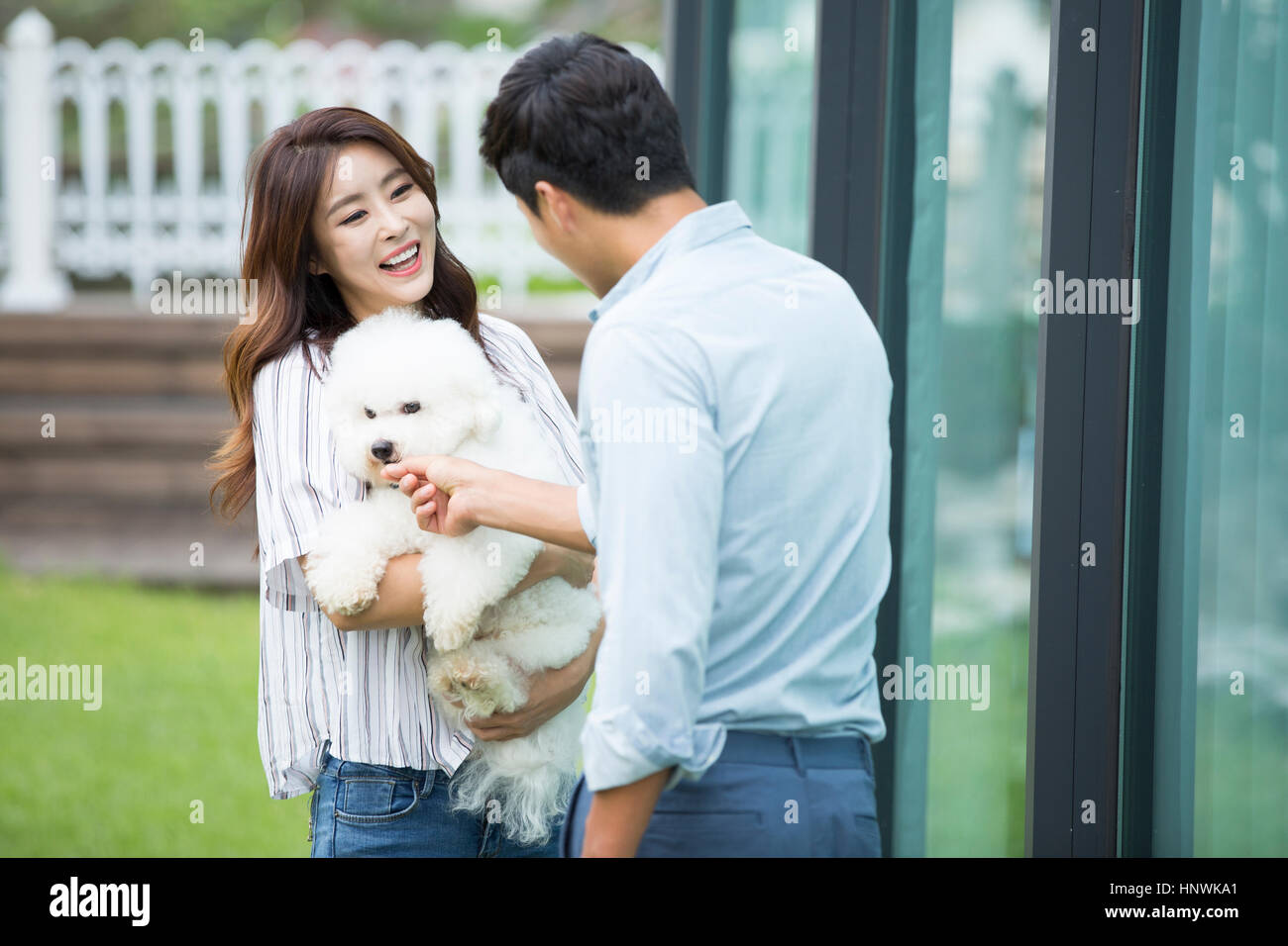Young smiling couple with pet Stock Photo - Alamy