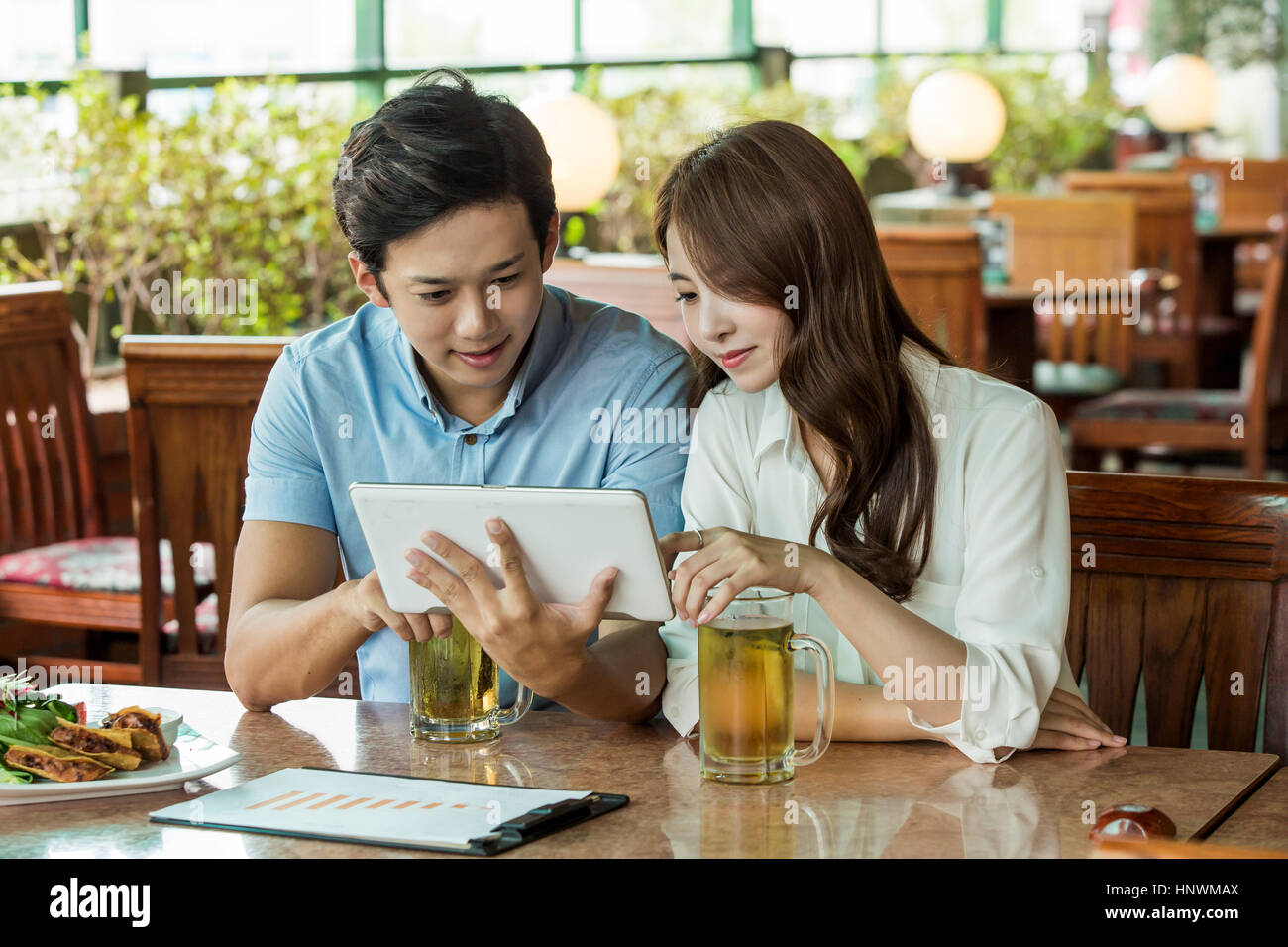 Teamwork people lifting tablet hi-res stock photography and images - Alamy