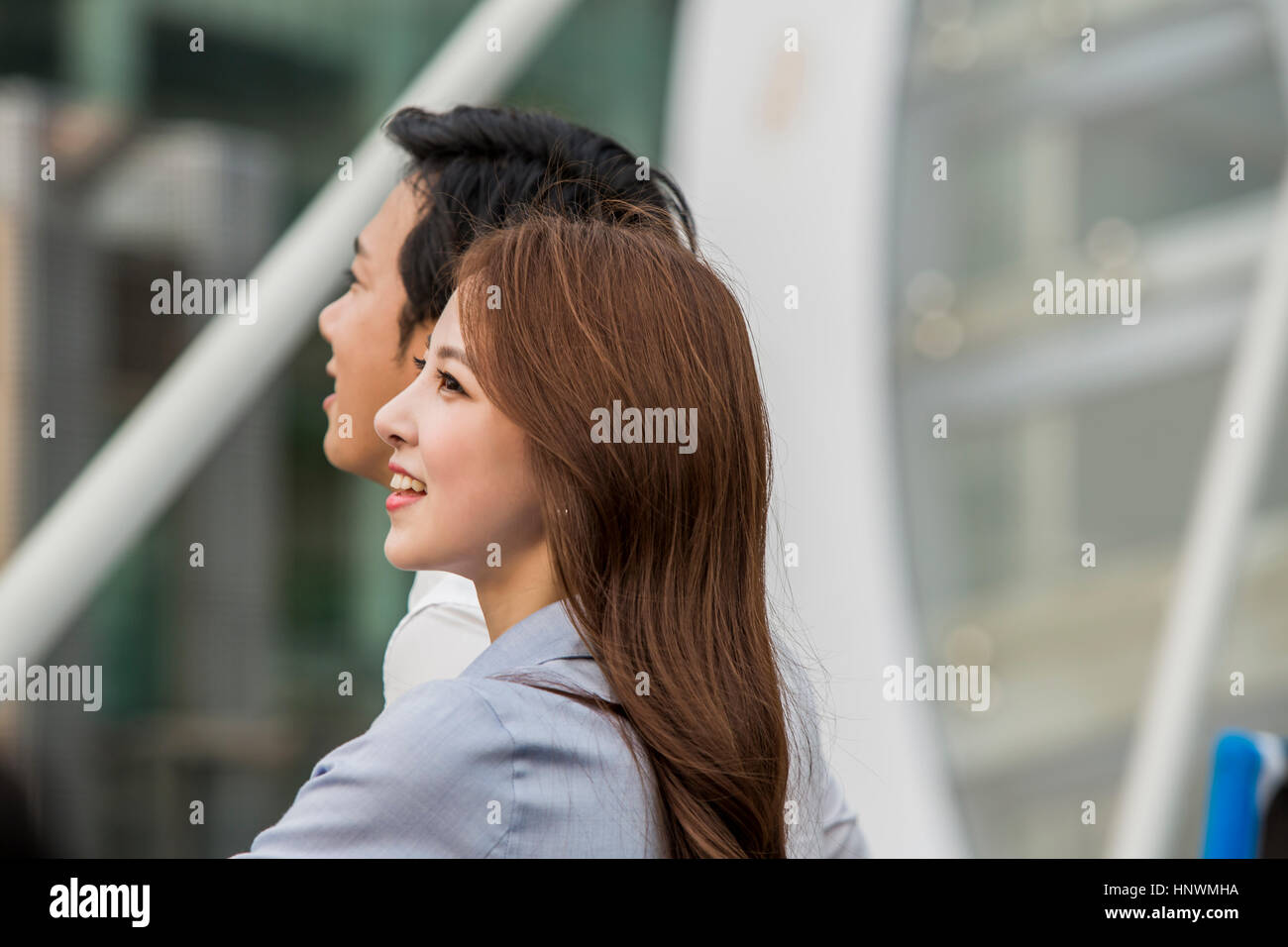 Side view portrait of young smiling business people Stock Photo - Alamy