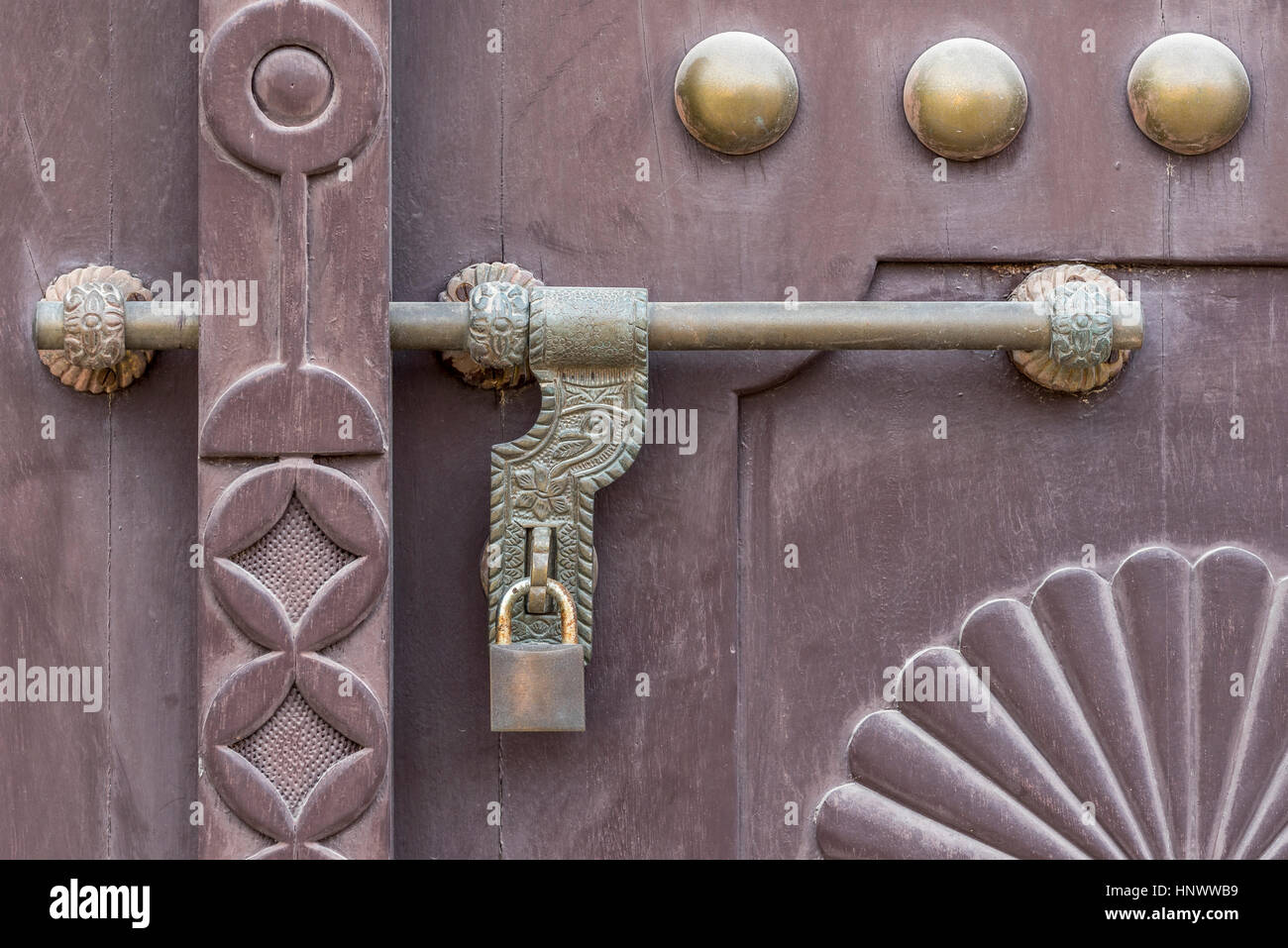 Door lock. Brass bolt and lock on a carved arabic style door in a ...