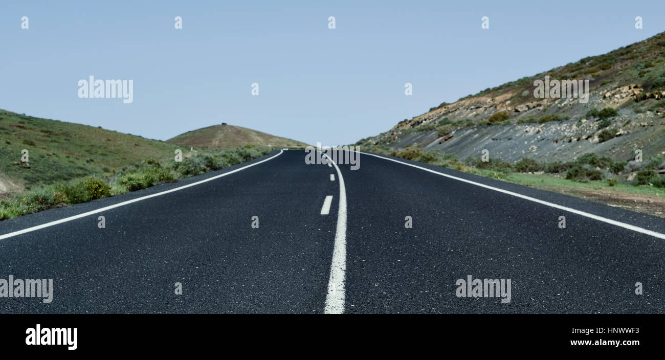 view of a lonely road in a rural landscape with no traffic Stock Photo ...