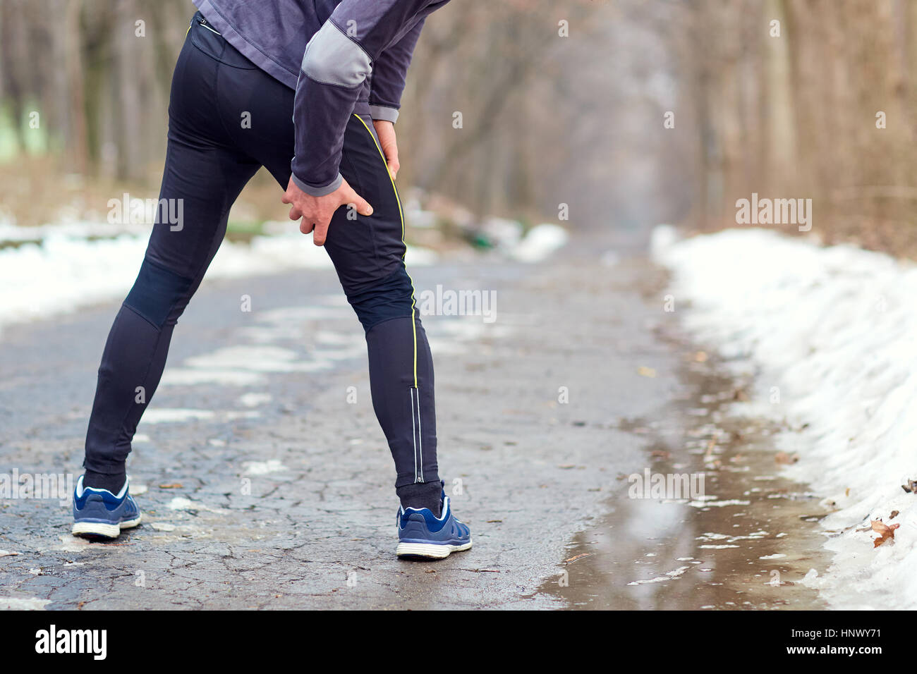 Injury while running in the winter spring autumn Stock Photo - Alamy