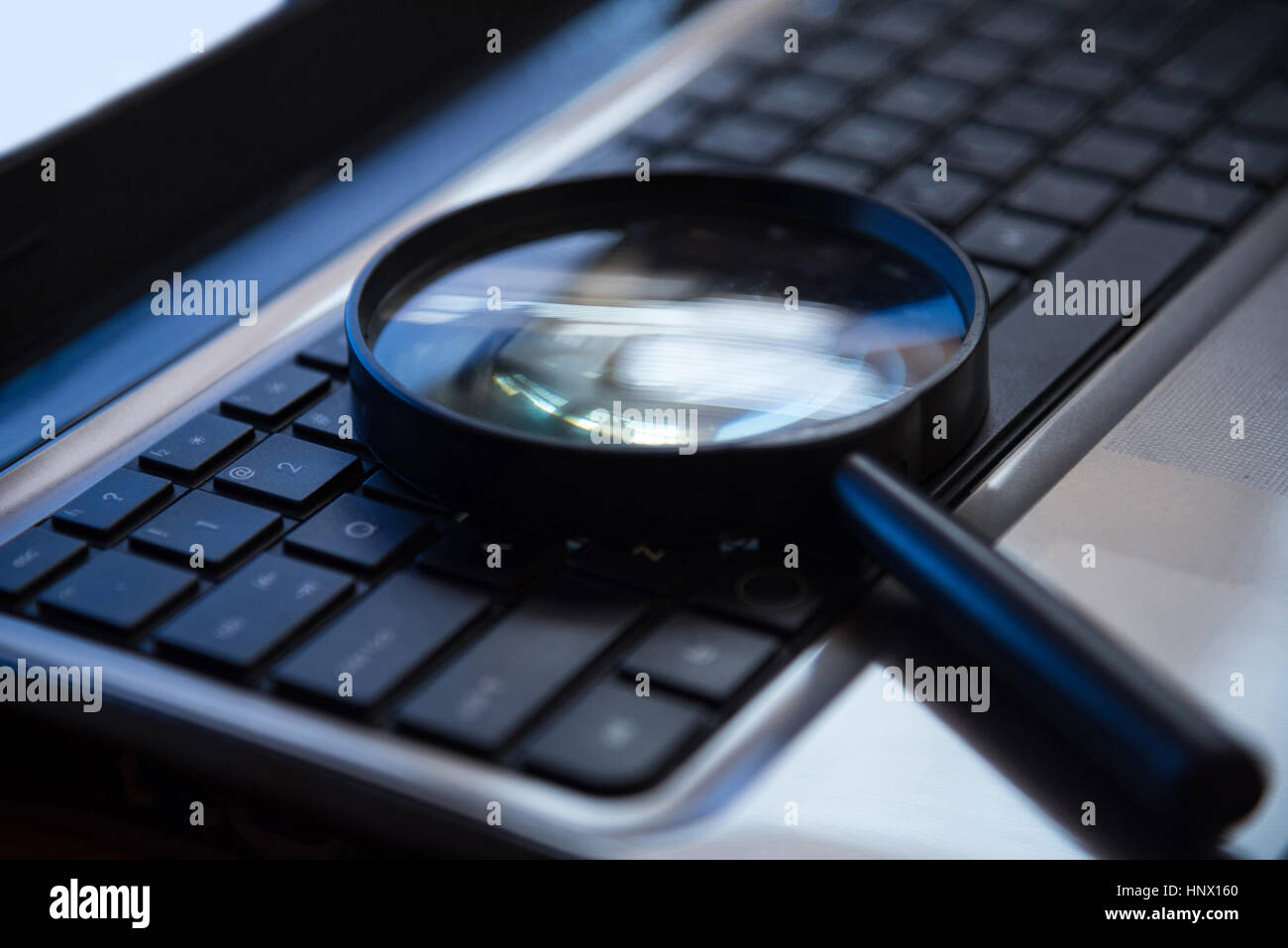 Selective focus on keyboard with magnifier searching concept in dark ...