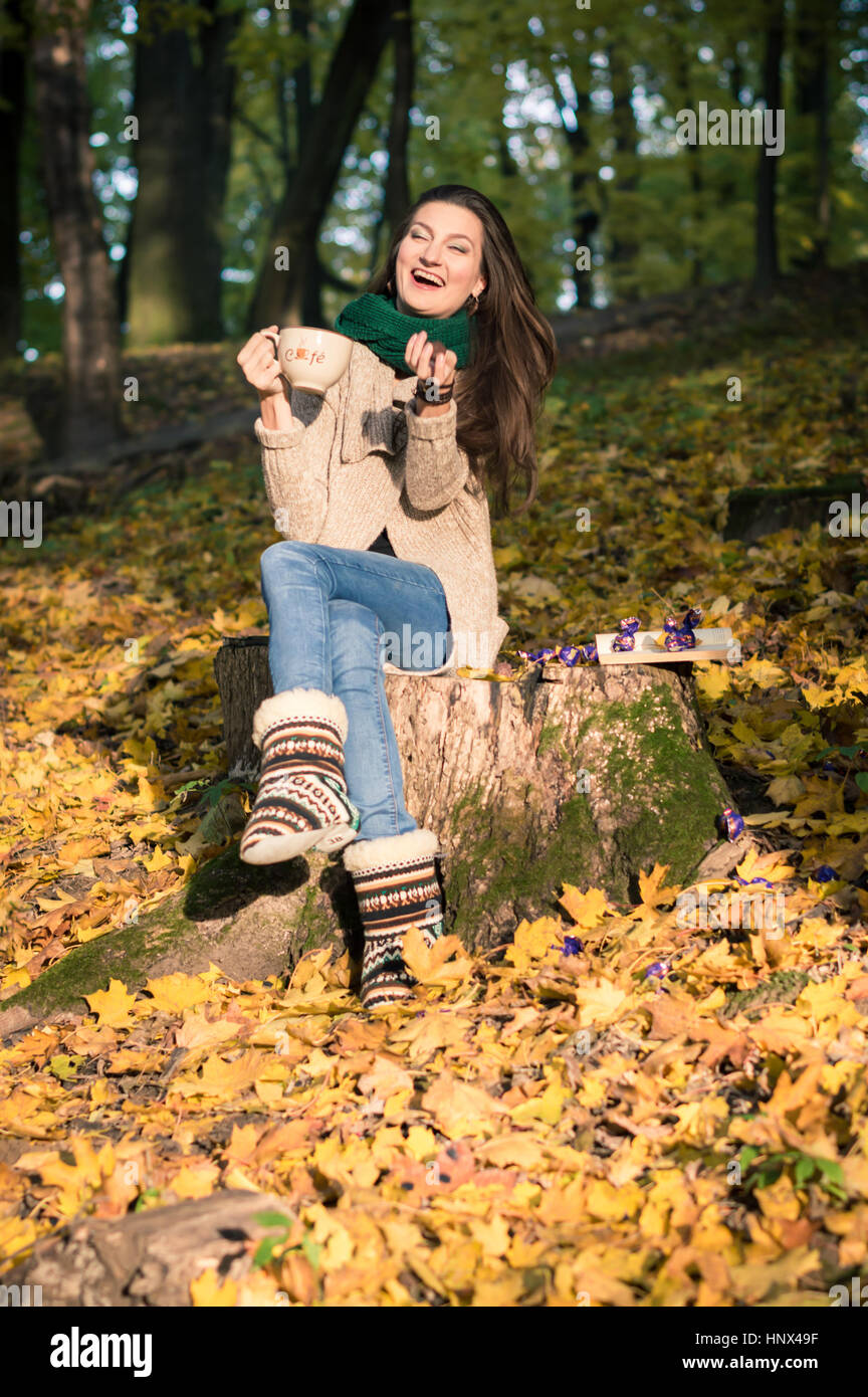 girl sitting on tree stump Stock Photo - Alamy