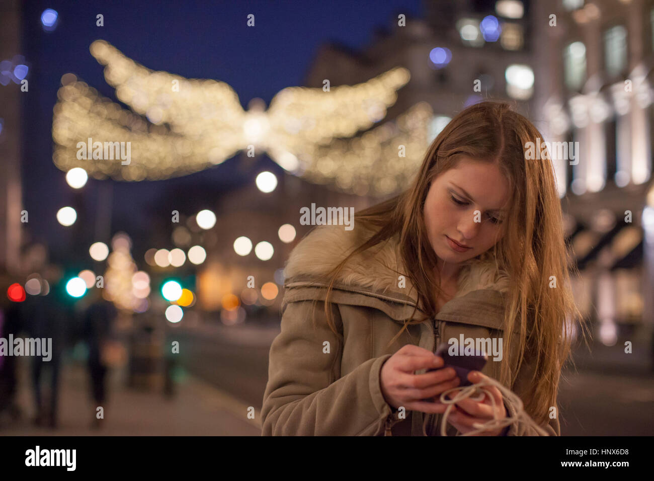Young woman using mobile phone in street, London, UK Stock Photo - Alamy