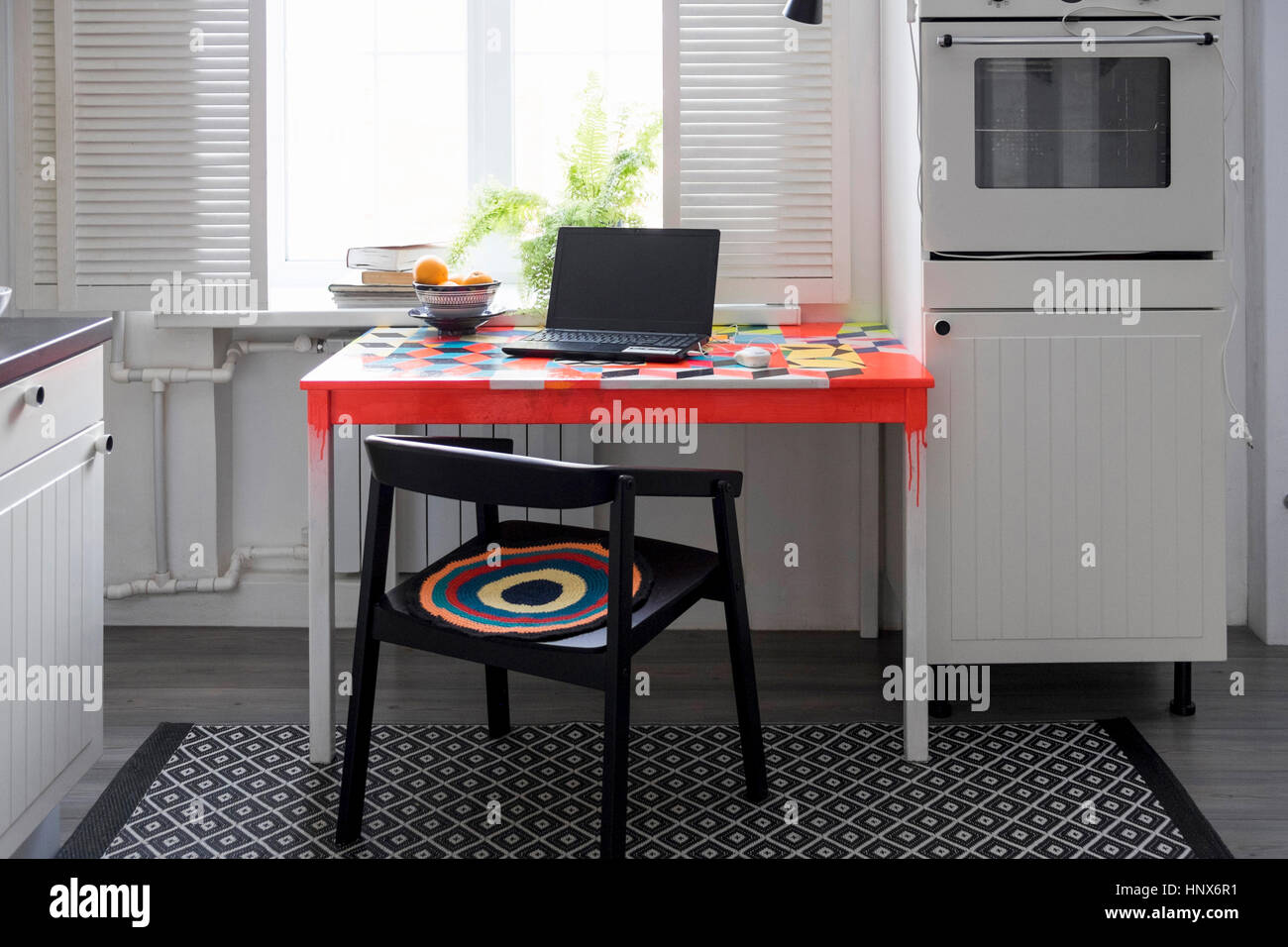 Kitchen with laptop on table Stock Photo - Alamy