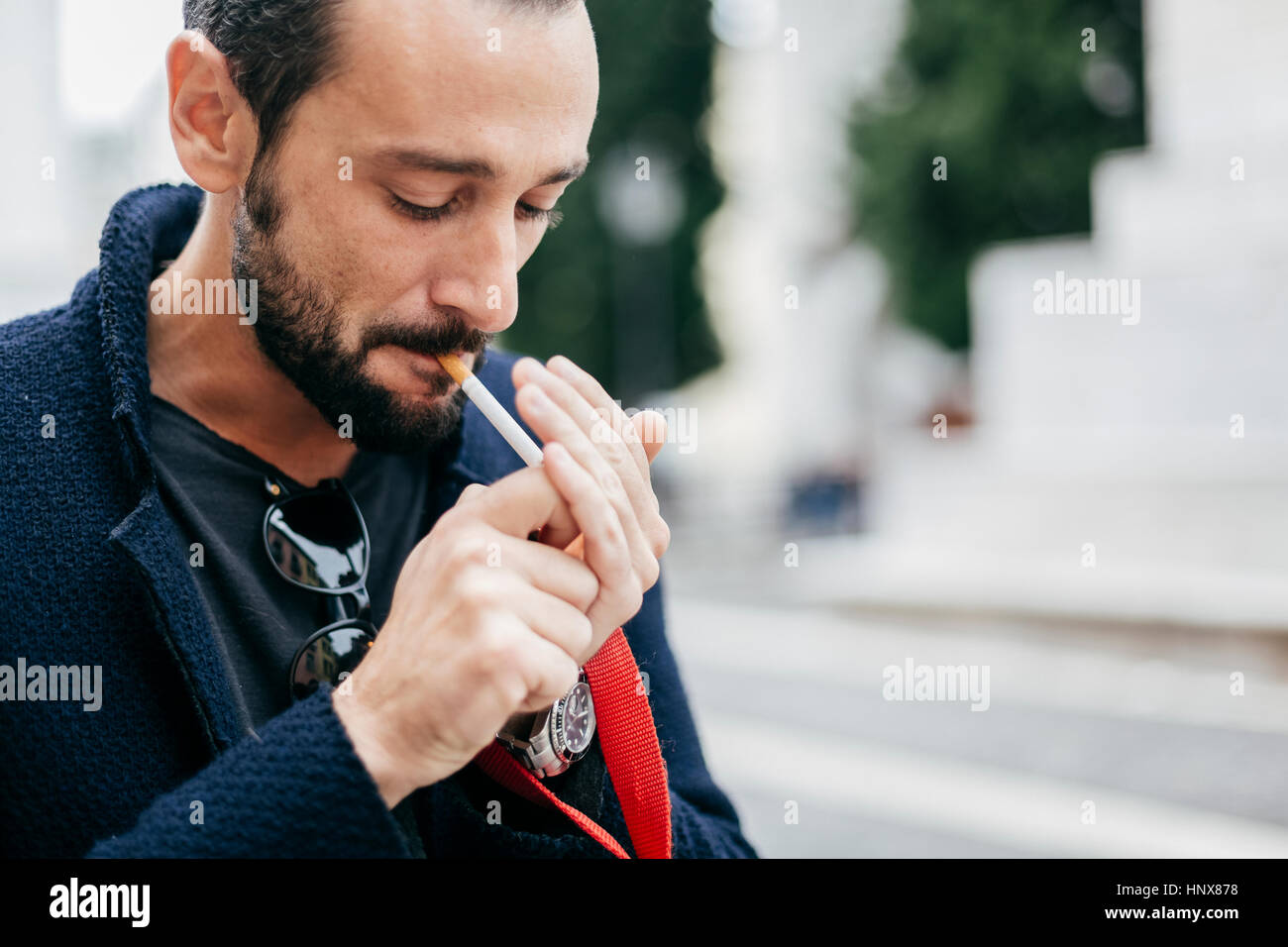 Handsome man smoking cigarette hi-res stock photography and images - Alamy