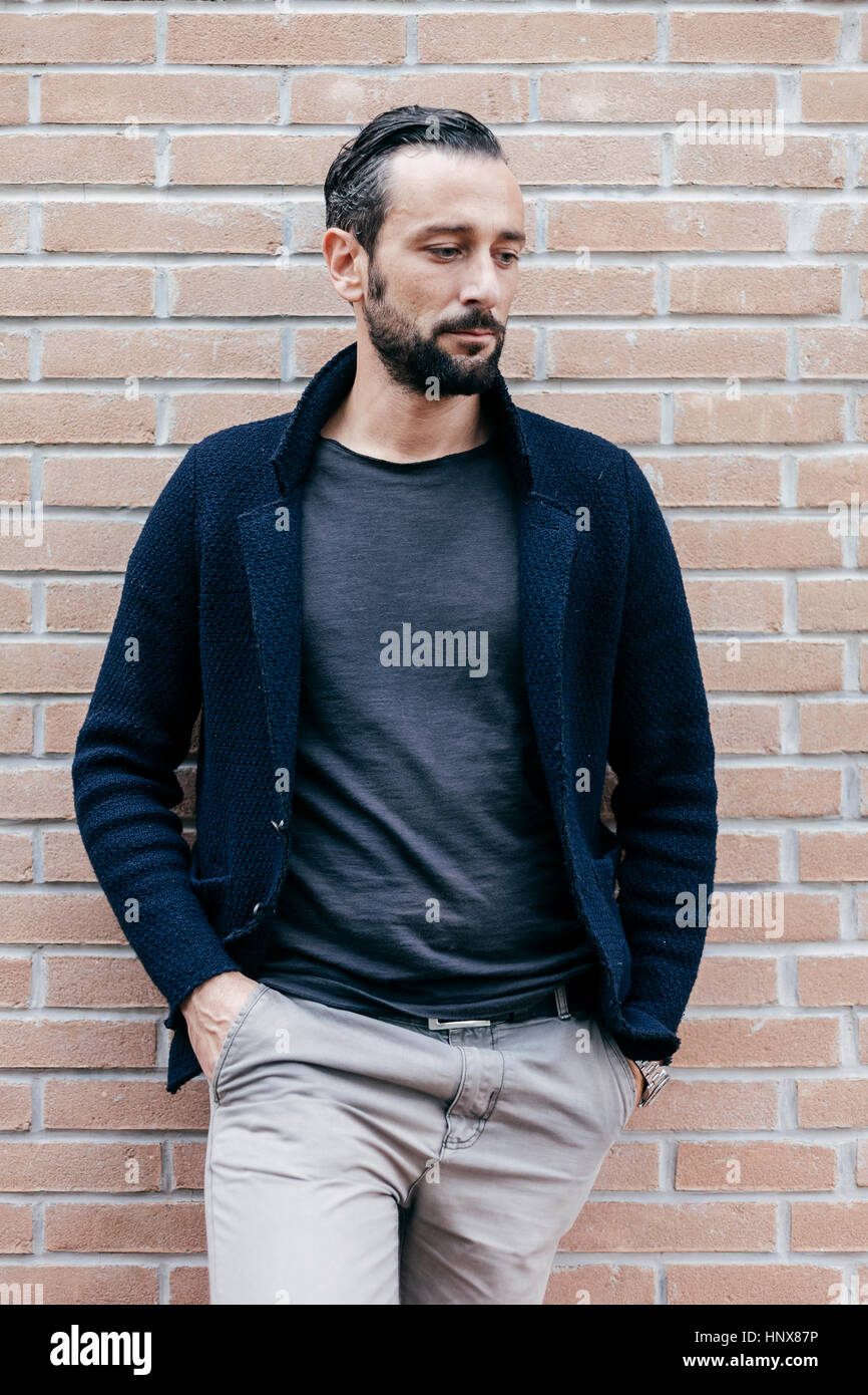 Man with hands in pockets looking away Stock Photo - Alamy