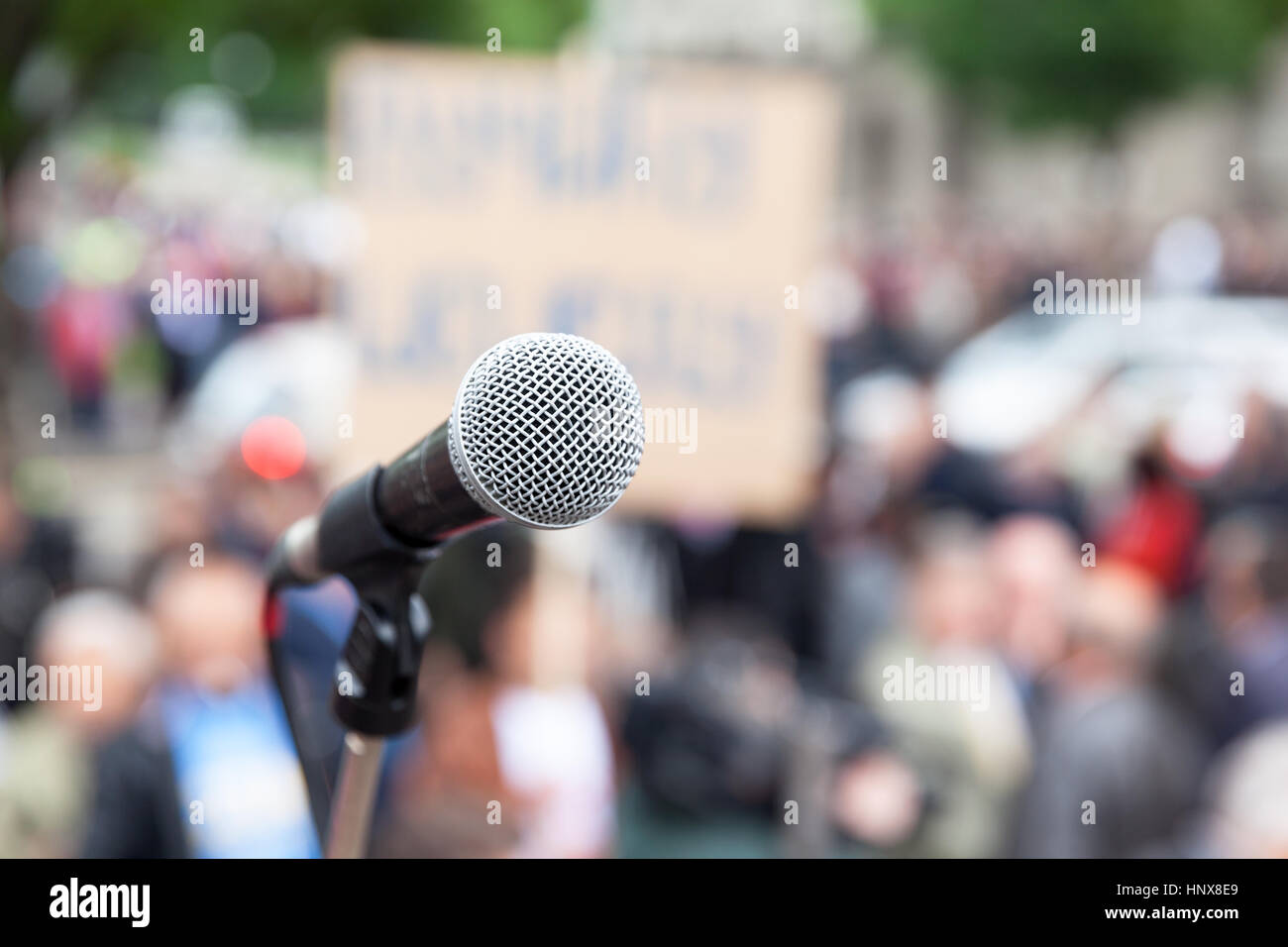 Microphone in focus, blurred crowd in background. Political rally Stock ...