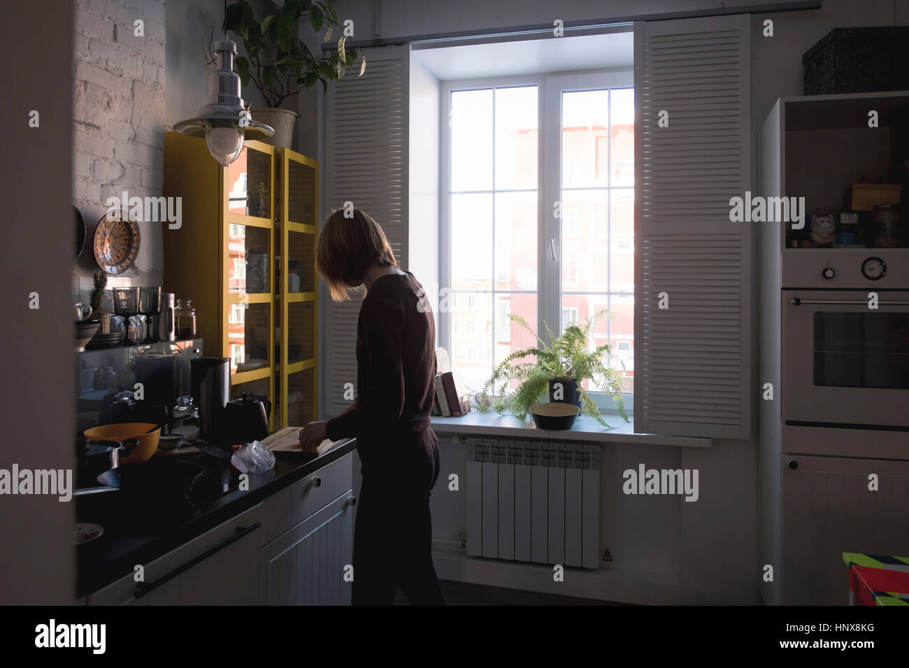 Woman at kitchen counter preparing food Stock Photo - Alamy