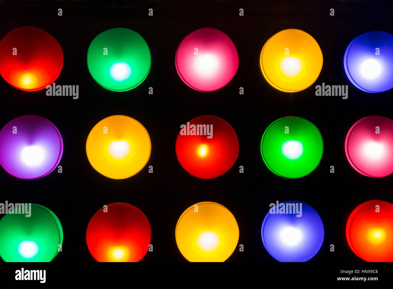 light of colorful circle lamp on black wall Stock Photo - Alamy
