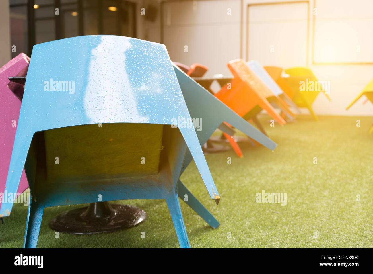 wet colorful plastic chair at terrace after raining Stock Photo - Alamy