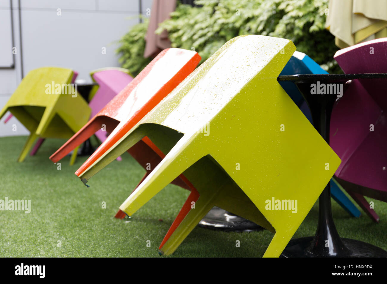 wet colorful plastic chair at terrace after raining Stock Photo - Alamy